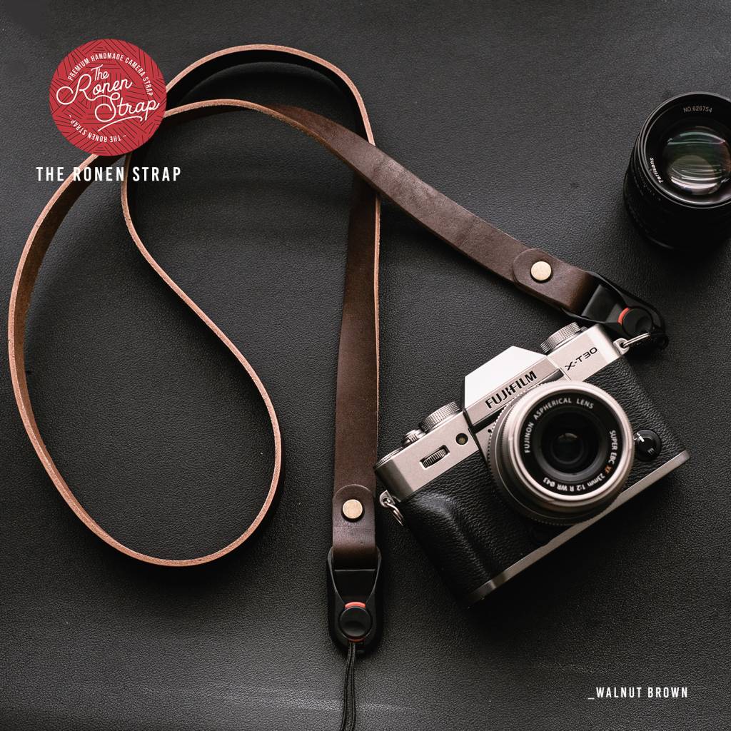 Handcrafted leather camera strap with quick release.